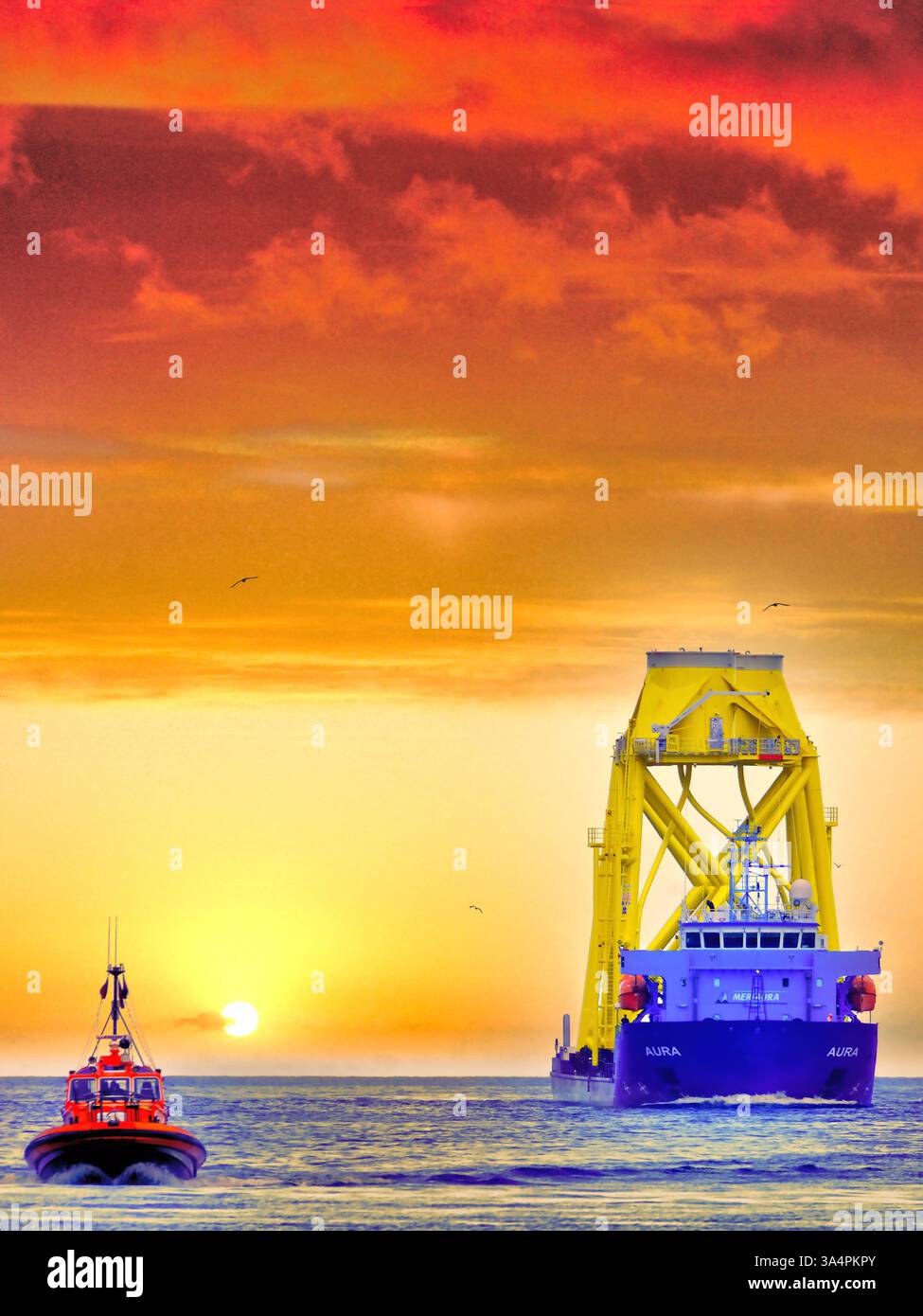 Cargo ship Aura with 2 wind turbine tops and pilot boat arriving at ...