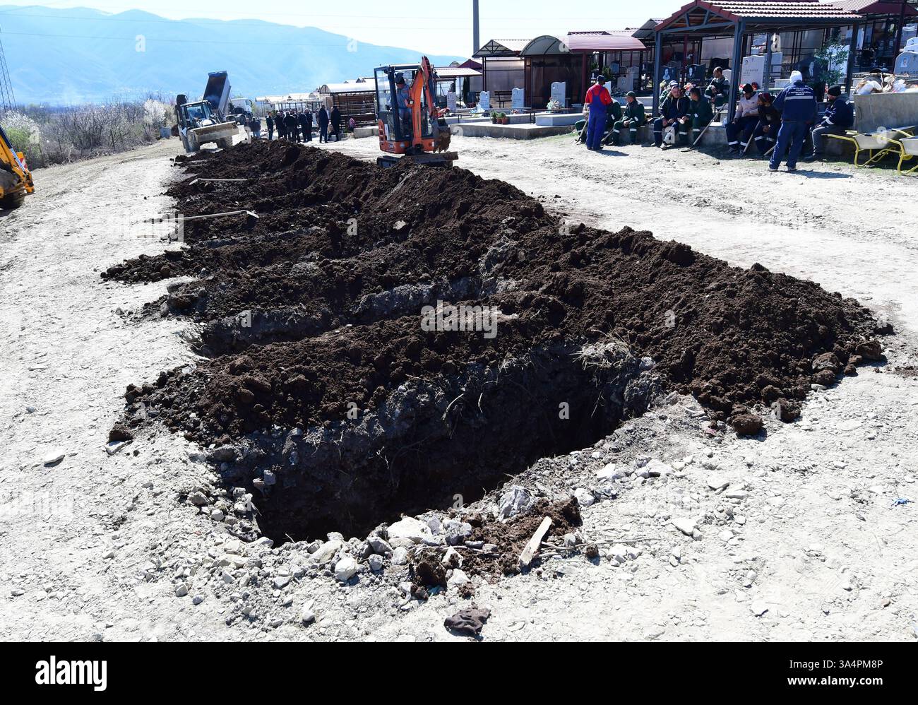 Workers are preparing the graves for the victims of Kocani night club ...