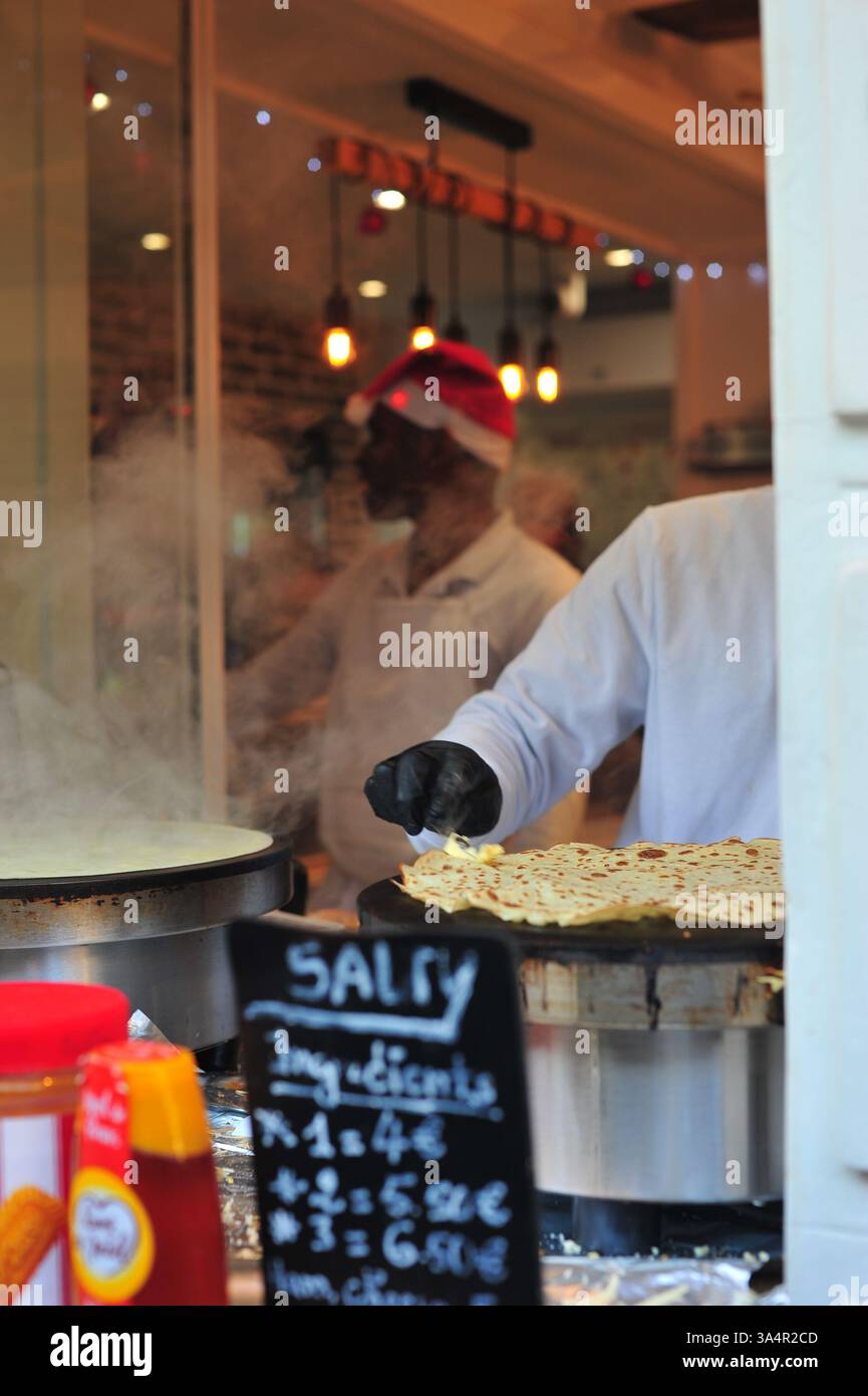 parisian black man cooking crepe in a tradicional restaurant in Paris ...