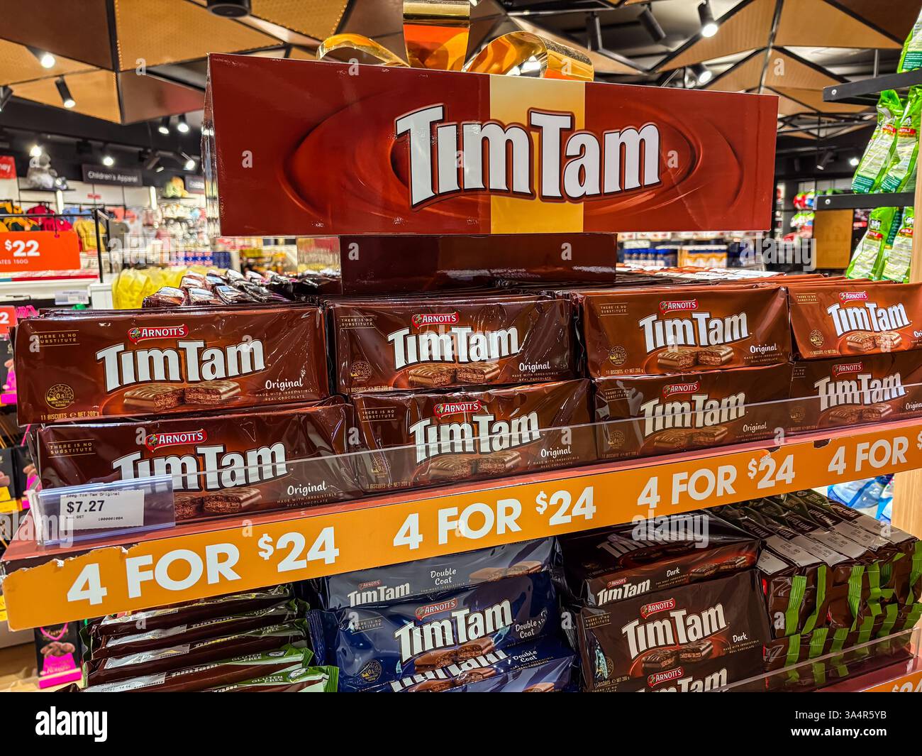 Display of Arnott's Tim Tam chocolate biscuits on a shelf with a ...