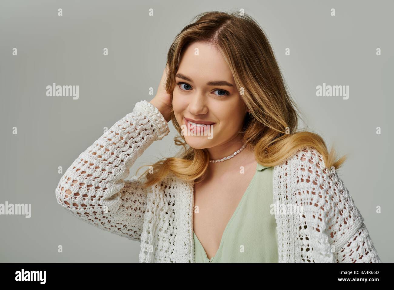 Young pretty woman in spring attire showcases her style with a cheerful ...