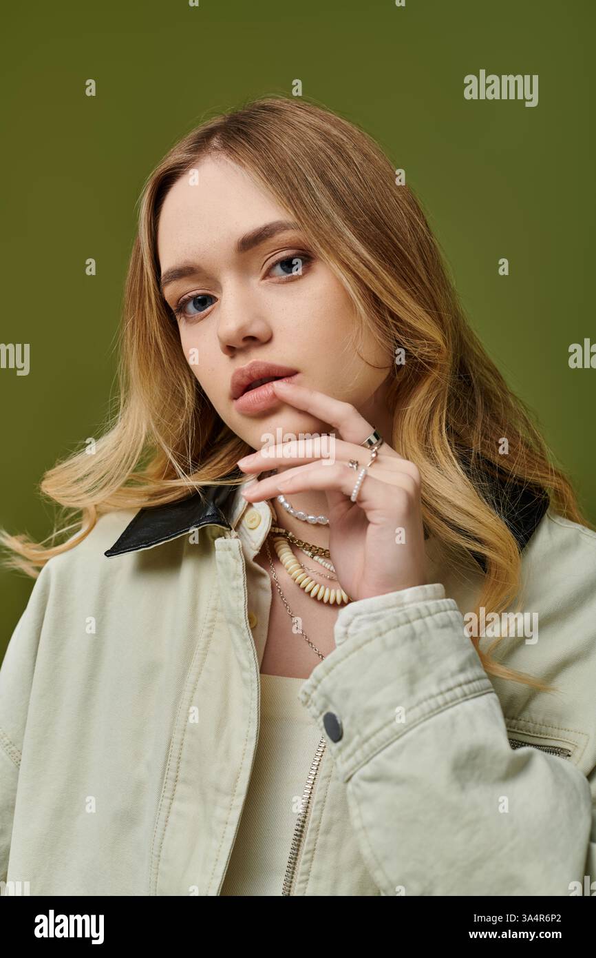 Charming young woman poses gracefully, highlighting her trendy spring ...