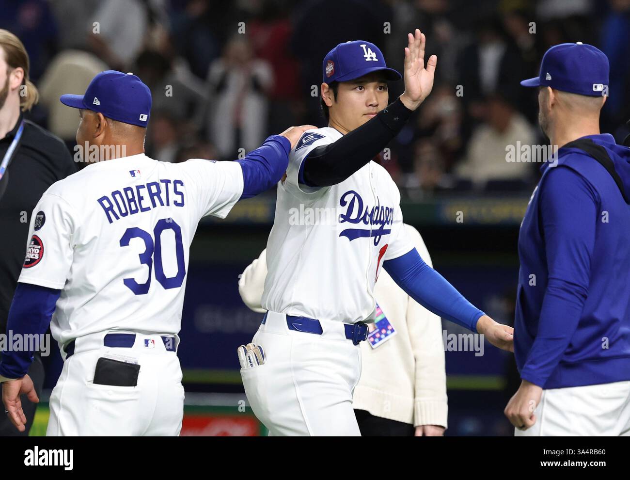 Los Angeles Dodgers Shohei Ohtani (C) responds to fans' cheers with ...