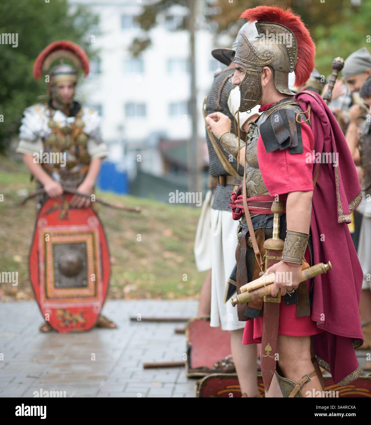 A group of individuals dressed as Roman soldiers during a historical ...