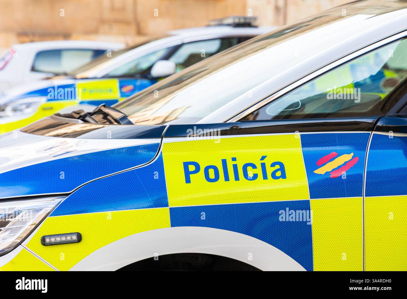A detailed close-up of Spanish police vehicles with blue and yellow ...