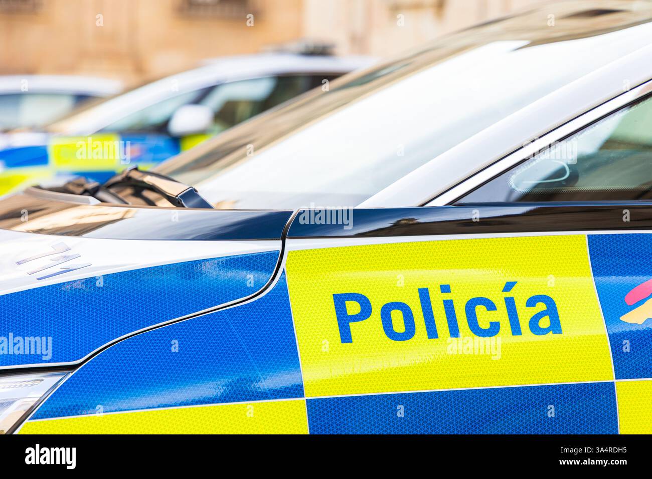 A detailed close-up of a Spanish police car featuring blue and yellow ...