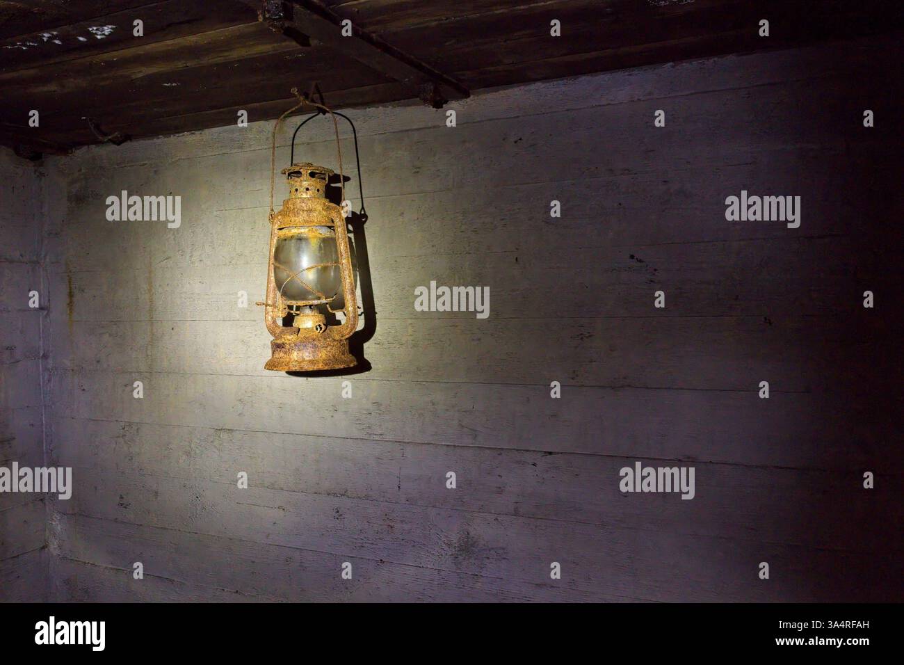 Old, rusty and dirty metal oil lamp hanging inside Stock Photo - Alamy