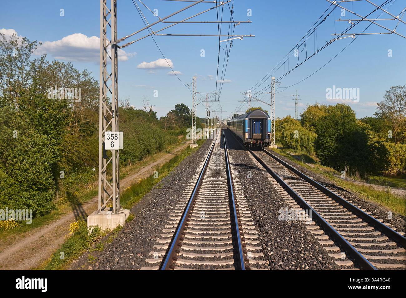 Rails with train, railway travel Stock Photo - Alamy