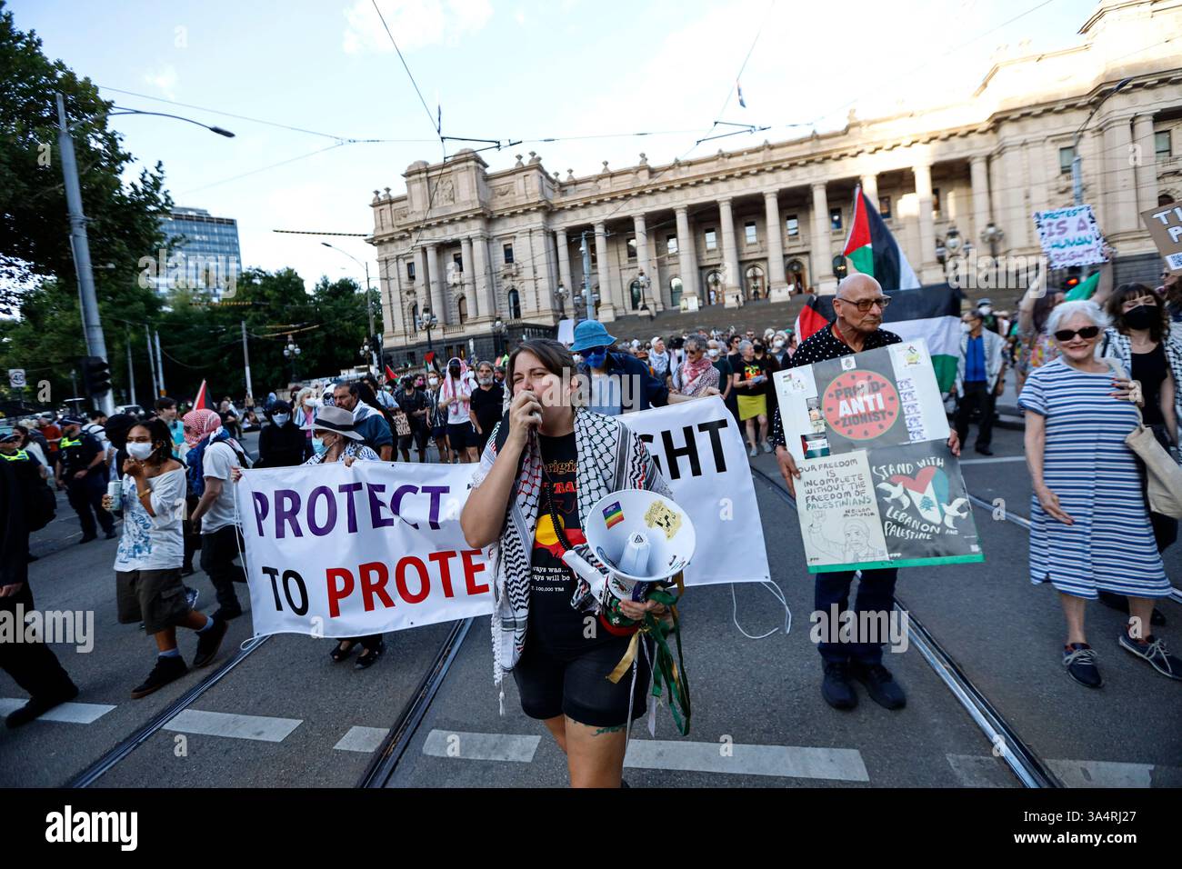 A protester shouts slogans through a megaphone during the rally. The ...