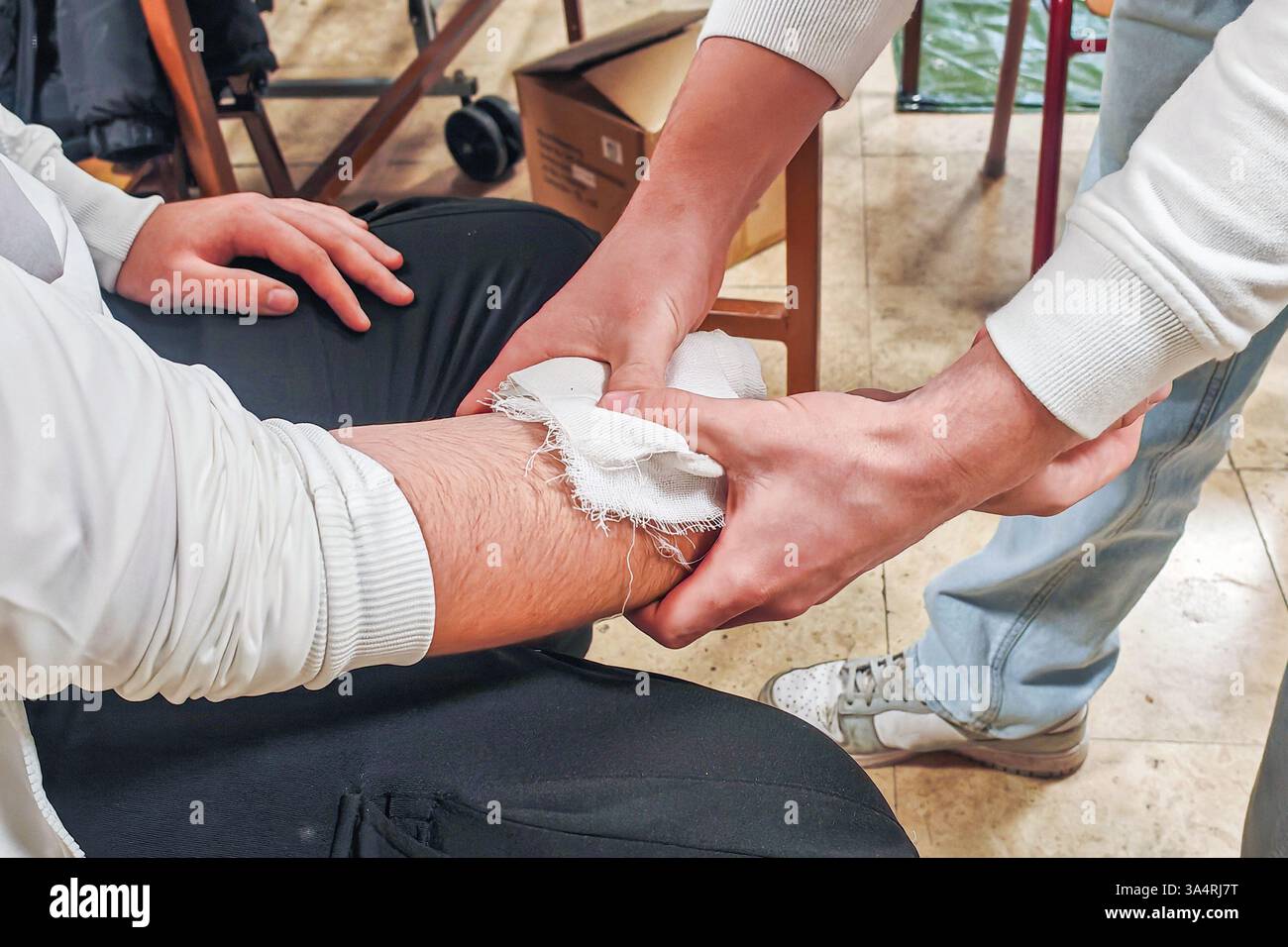 First aid practice for bandaging an injured arm Stock Photo - Alamy