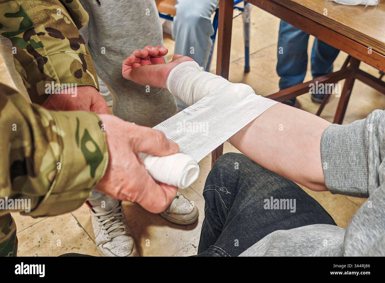 First aid practice for bandaging an injured arm Stock Photo - Alamy