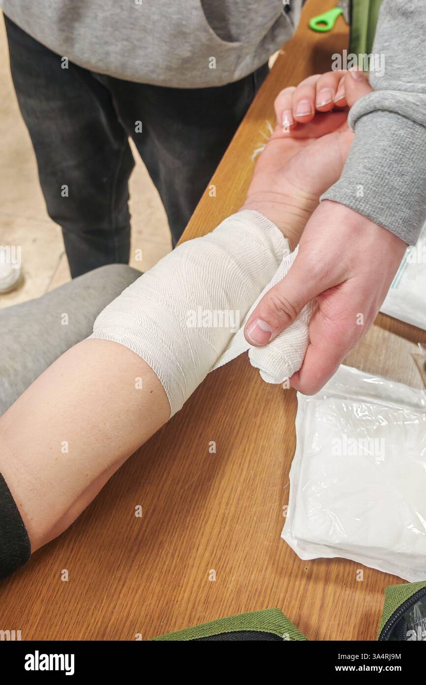 First aid practice for bandaging an injured arm Stock Photo - Alamy
