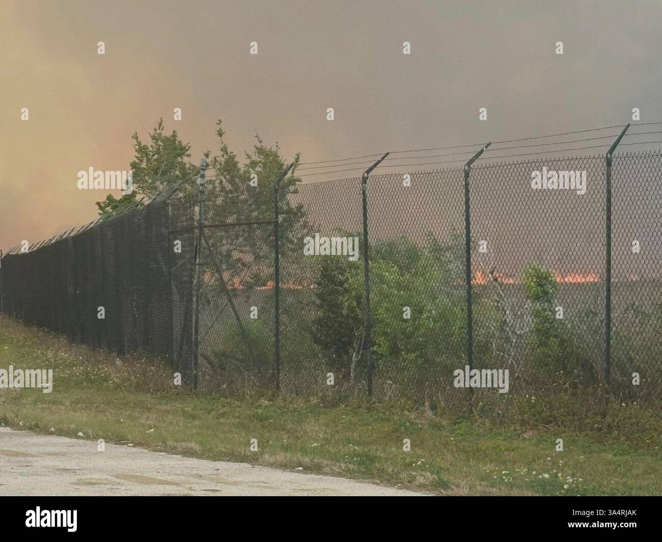This photo provided by shows smoking from fires on Miami-Dade side fill ...