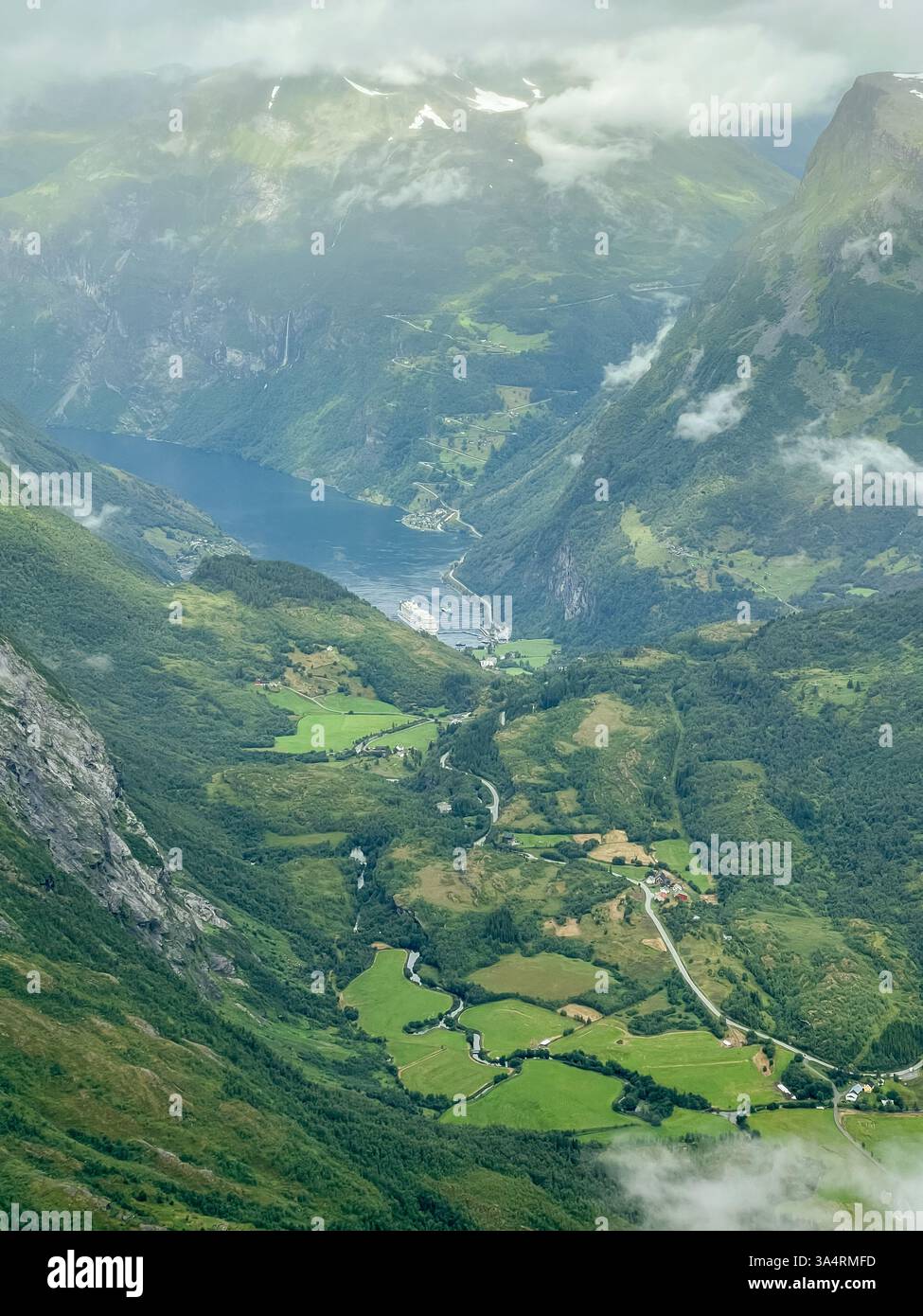 Aerial view of the Geirangerfjord valley in Norway, with green fields ...