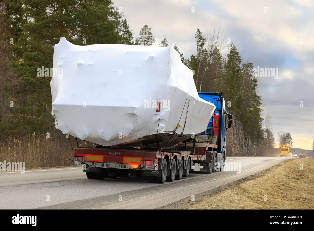 Scania truck gooseneck trailer hauls large tarpaulin covered boat on ...