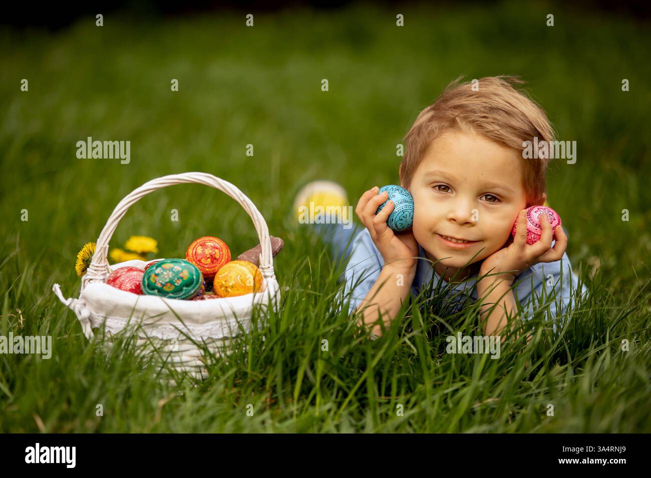 Cute preschool child, whipping his sister on Easter with twig, braided ...