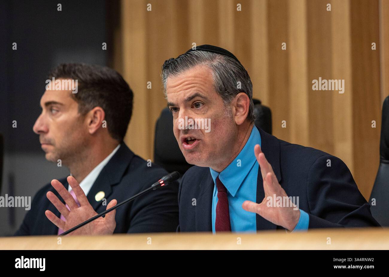 Miami Beach Mayor Steven Meiner, second from left, speaks to a full ...