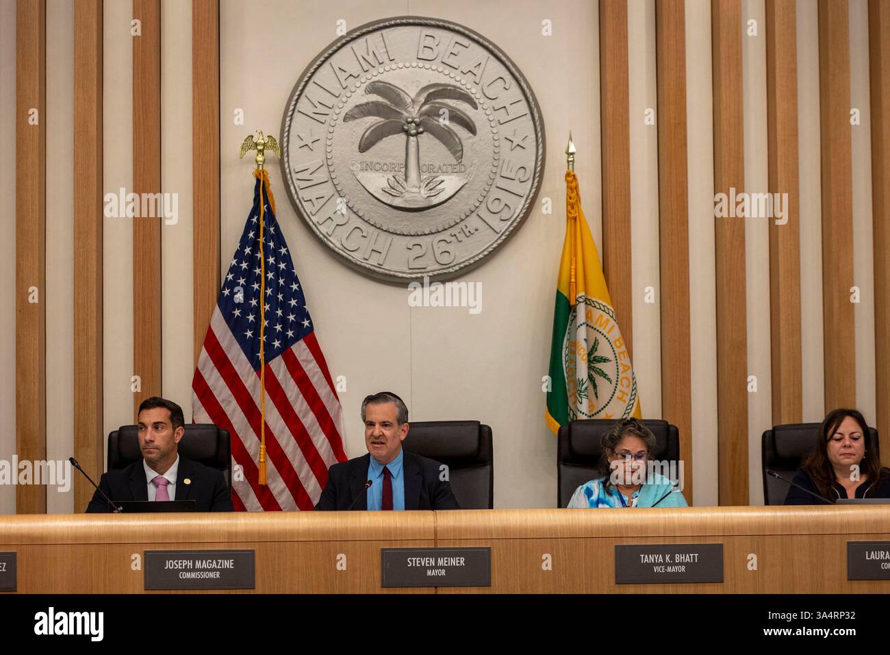 Miami Beach Mayor Steven Meiner, second from left, speaks to a full ...