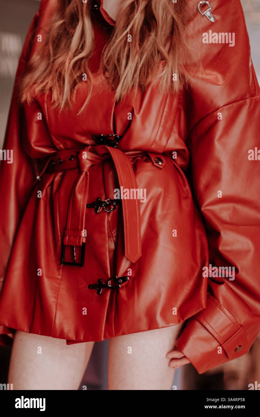 Brown leather cropped jacket with belt on female figure, close up ...