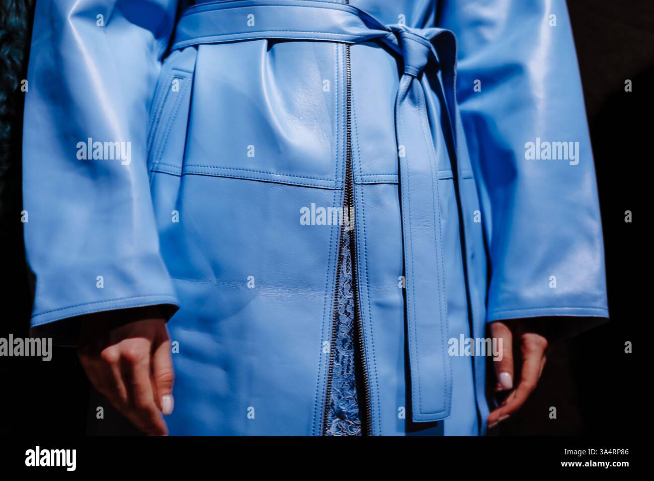 Bright blue leather jacket with belt on female figure, close up stylish ...