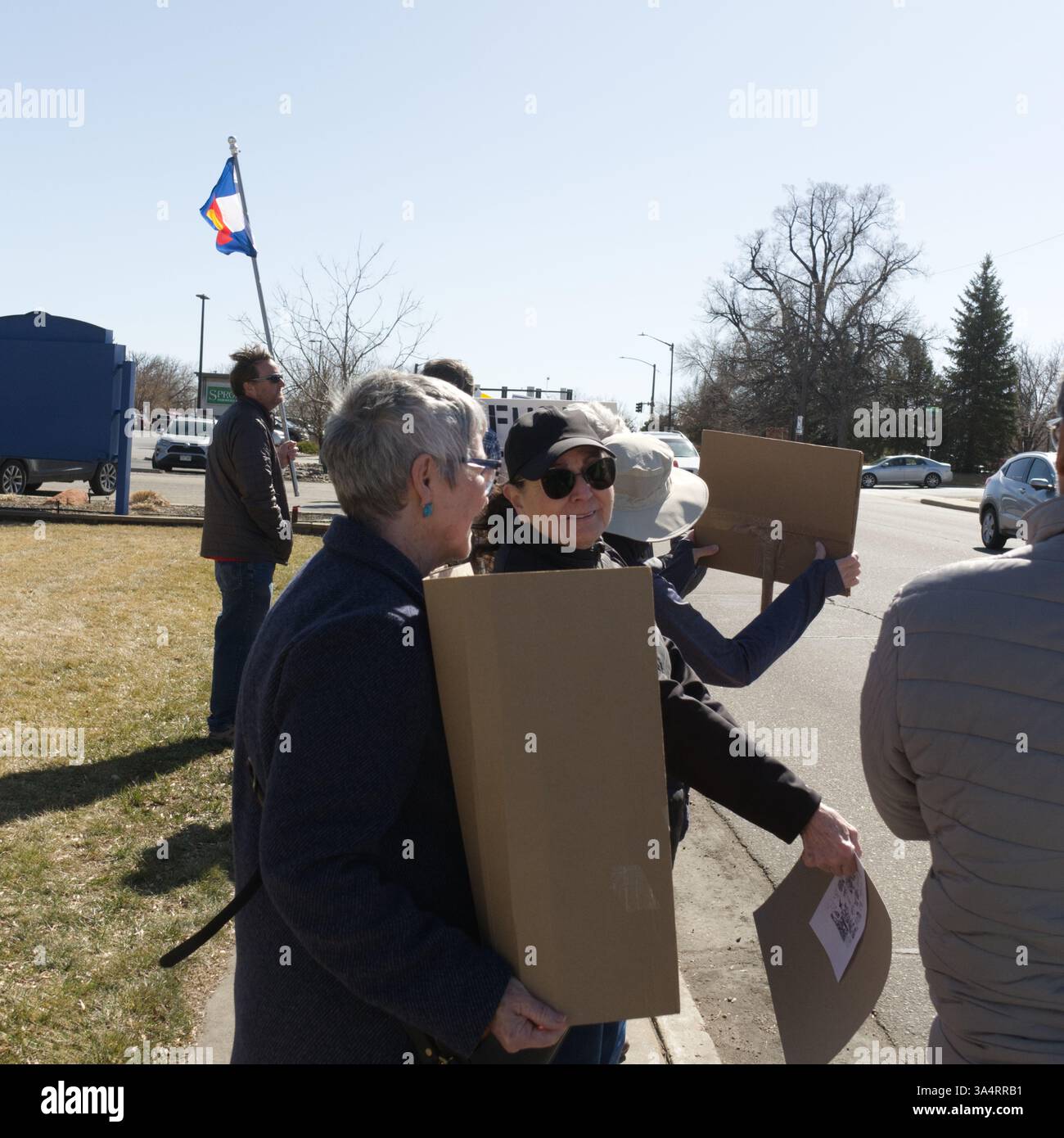 Loveland Colorado protests in March of 2025. People with signs line the ...