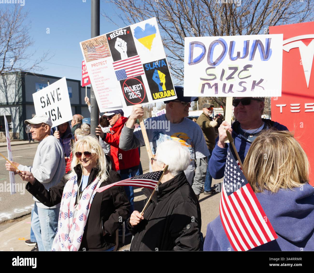 Protests against Elon Musk in Loveland Colorado. Demonstrators line the ...