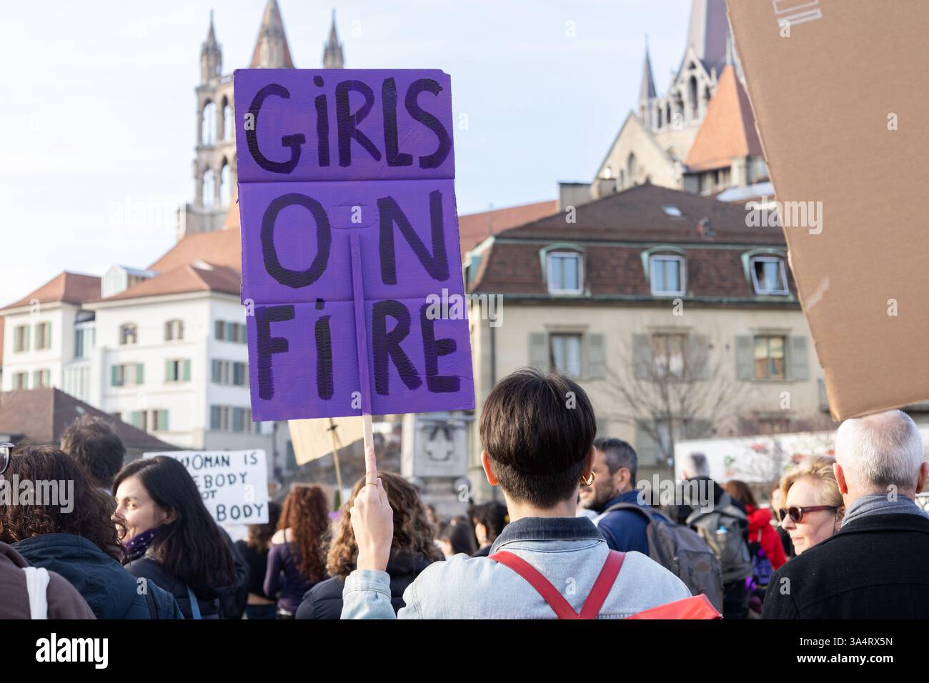 Lausanne, Switzerland. 8th March, 2025. Protester holding a "Girl is on ...