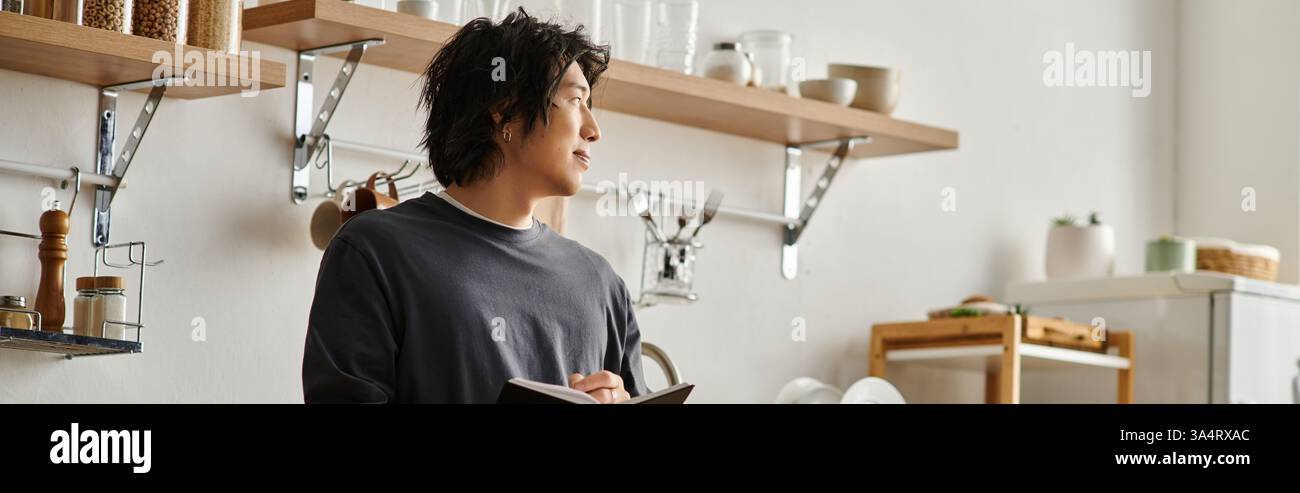 Handsome young man engages in online learning at home, balancing study ...