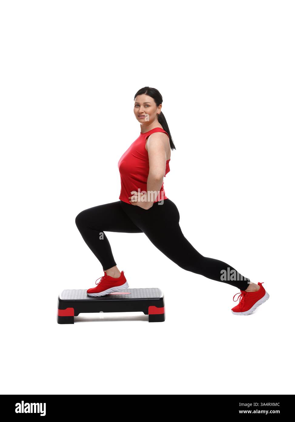 Plus size woman in gym clothes doing exercise with step platform on ...