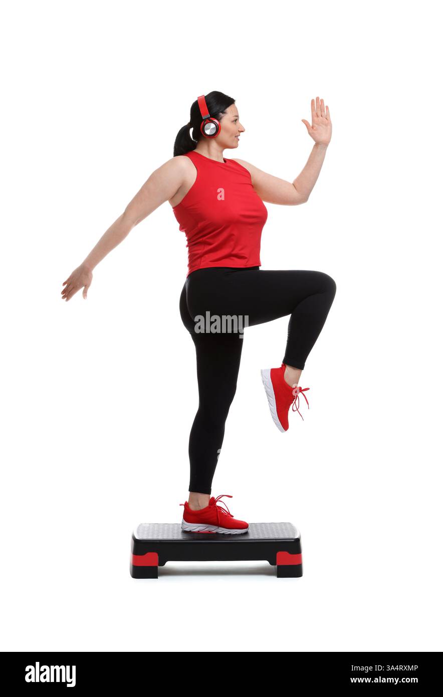 Plus size woman in gym clothes doing exercise with step platform on ...