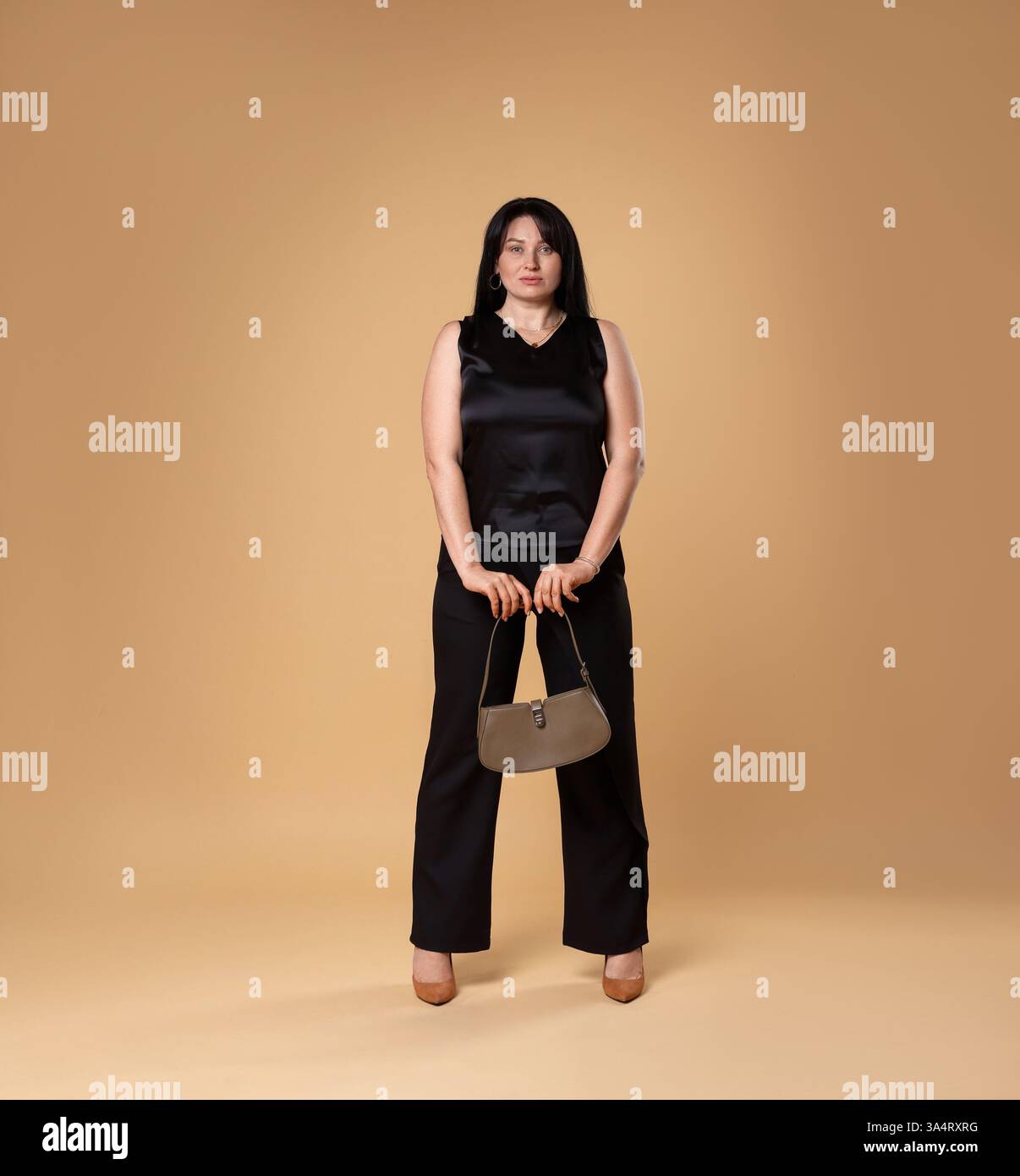 Elegant plus size model with bag on beige background. Overweight Stock ...