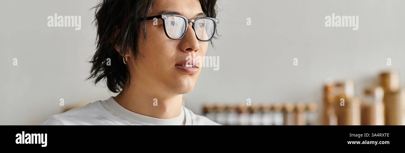 A good looking young man reflects thoughtfully in a stylish home ...