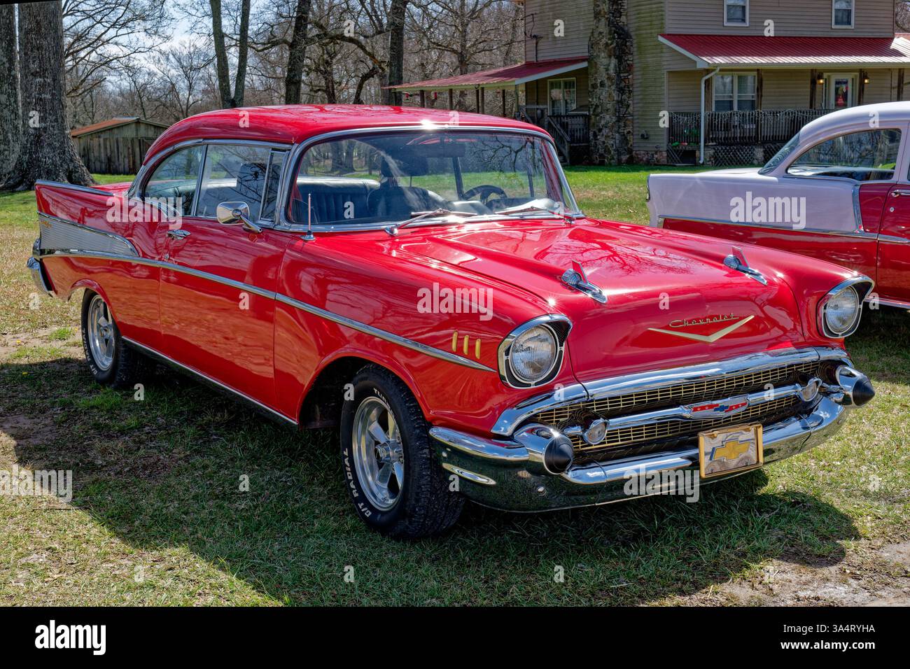 A shiny bright cherry red restored 1957 Chevy Bel Air 2-door coupe car ...