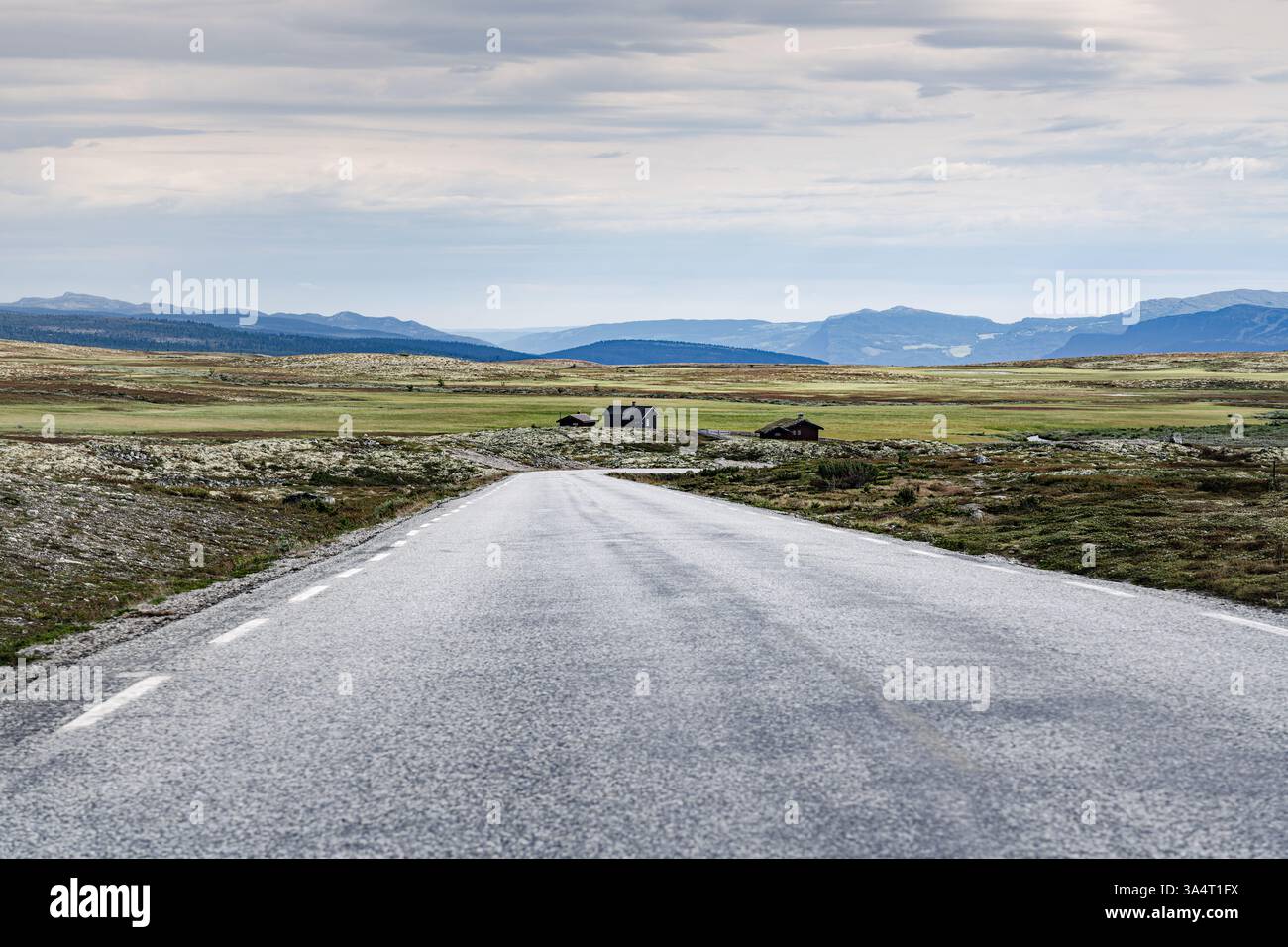 A solitary houses by a road sits in the wide, rugged tundra of Norway ...