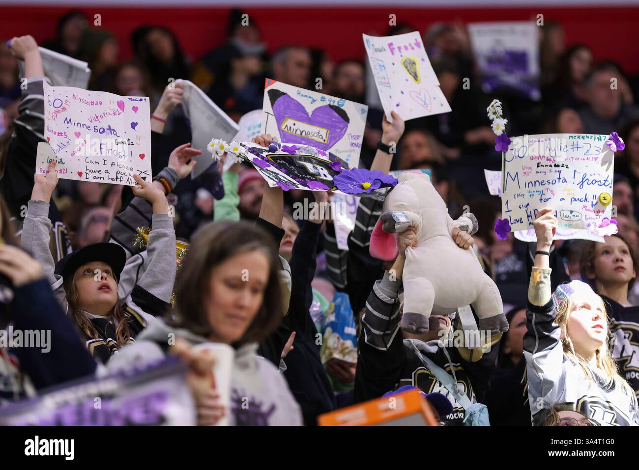 DETROIT, MI - MARCH 16: Young fans hold up signs and cheer during the ...