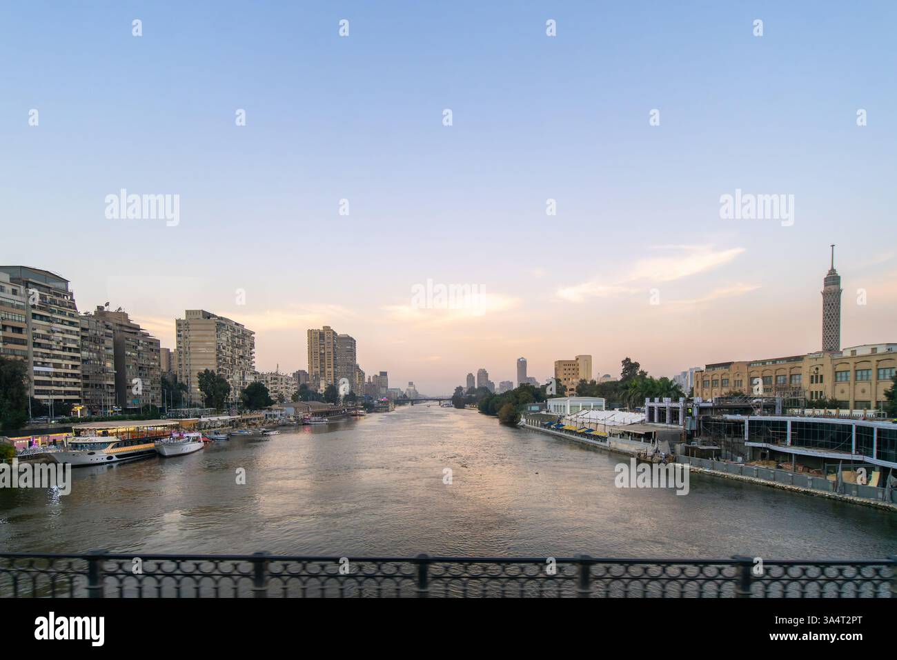 The Cairo skyline at dusk, with the Nile River flowing through the city ...