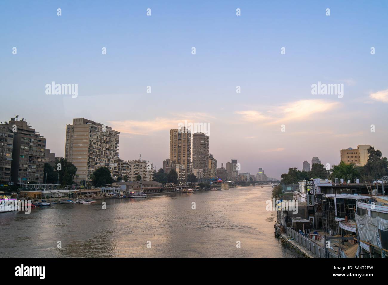 The Cairo skyline at dusk, with the Nile River flowing through the city ...