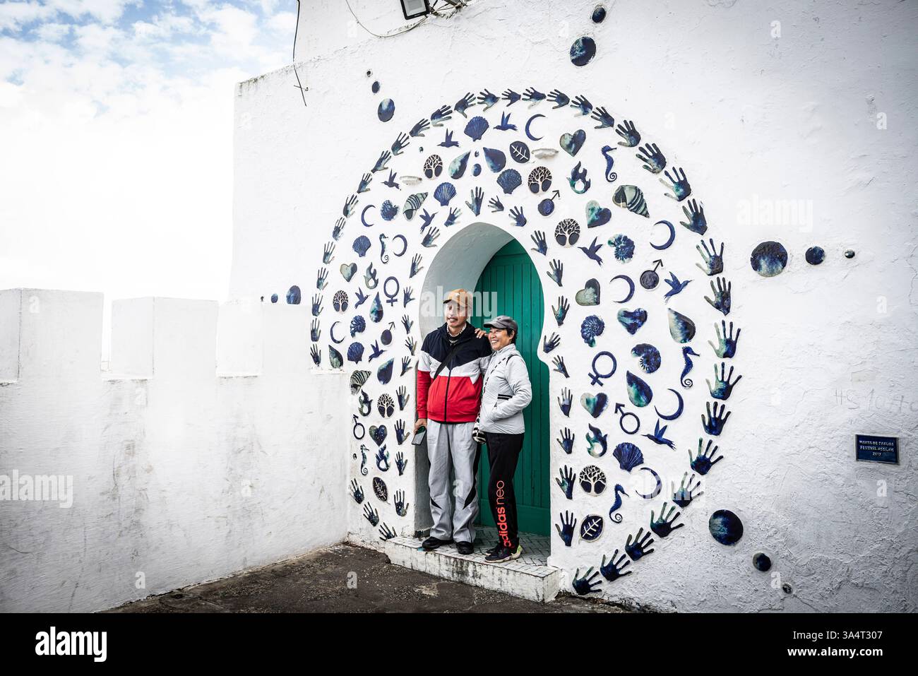 asian tourists taking pictures in the famous graffiti of the hands ...