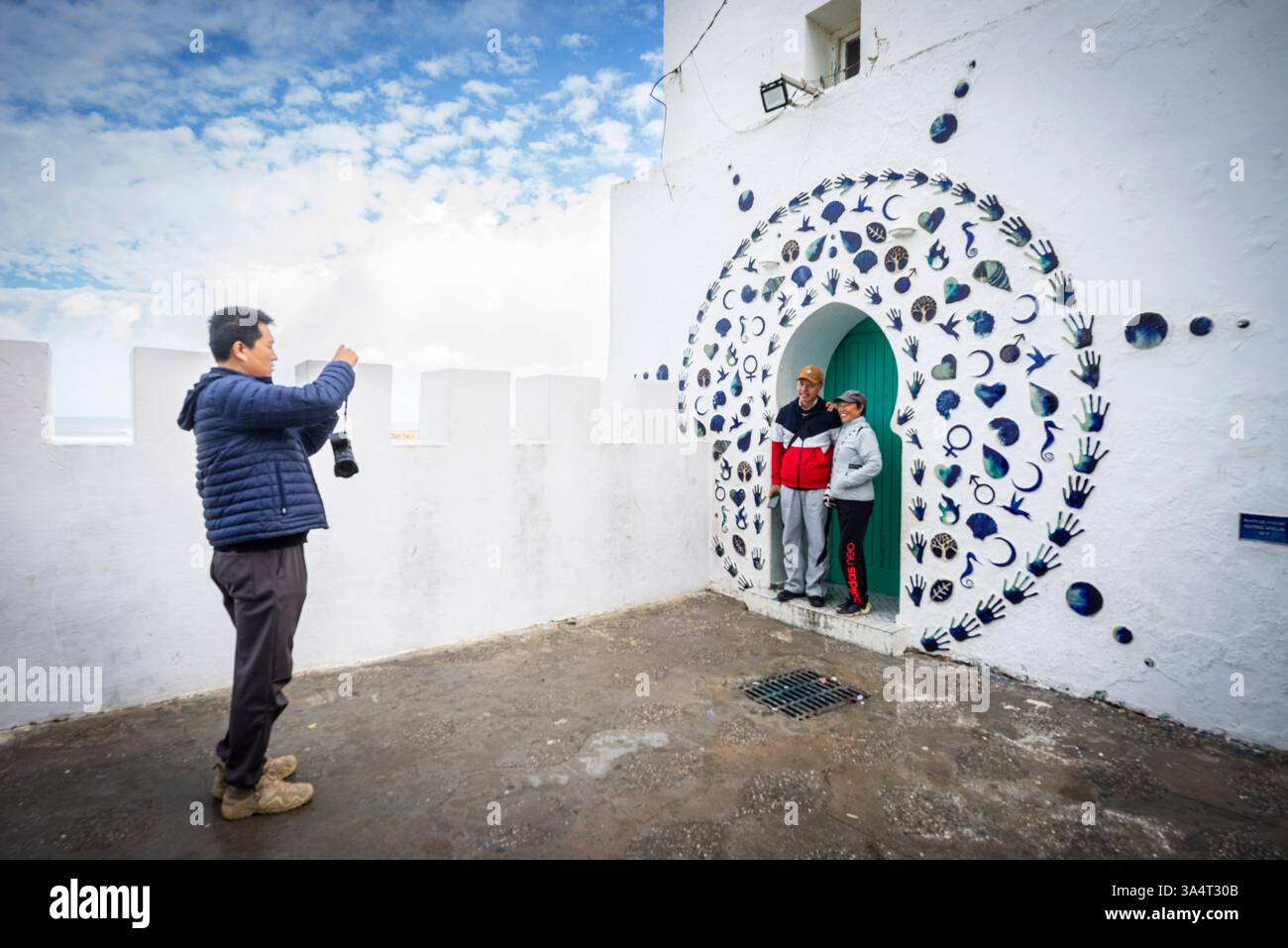 asian tourists taking pictures in the famous graffiti of the hands ...