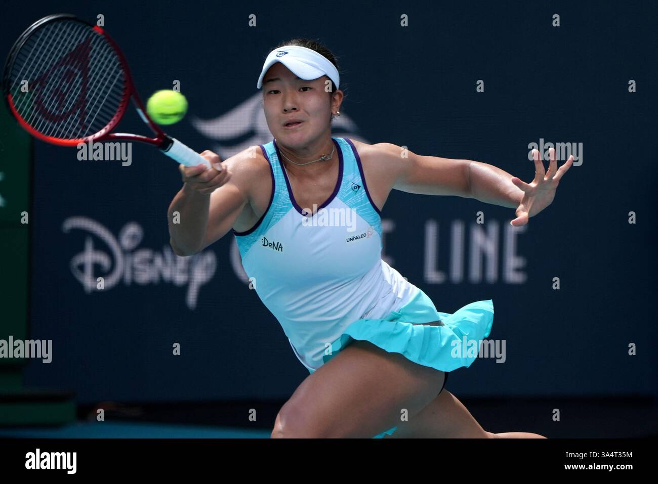 Sayaka Ishii, of Japan, hits a return to Emma Raducanu, of Great Britain, during the Miami Open ...