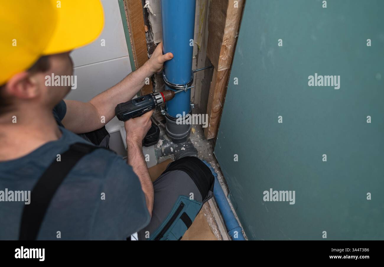 A man installing a new sewer drain stack Stock Photo - Alamy