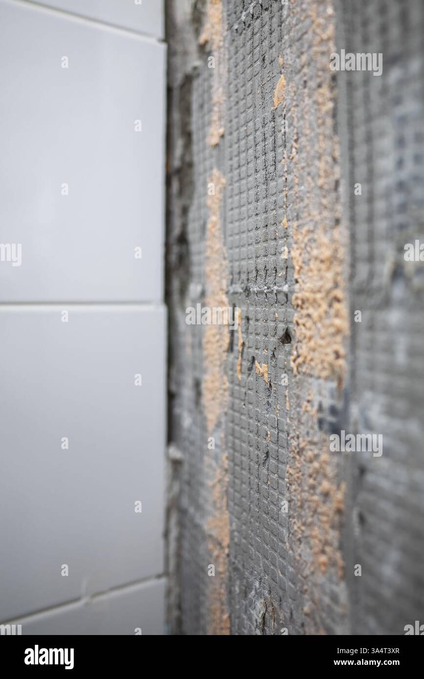 Partial tiling on one wall during renovation Stock Photo - Alamy