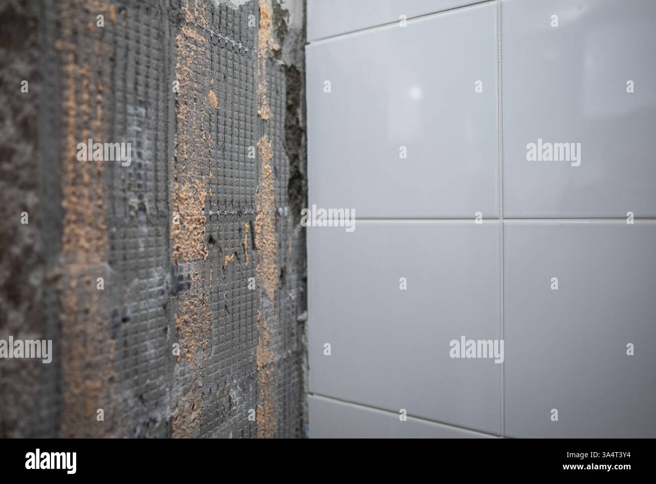 Partial tiling on one wall during renovation Stock Photo - Alamy