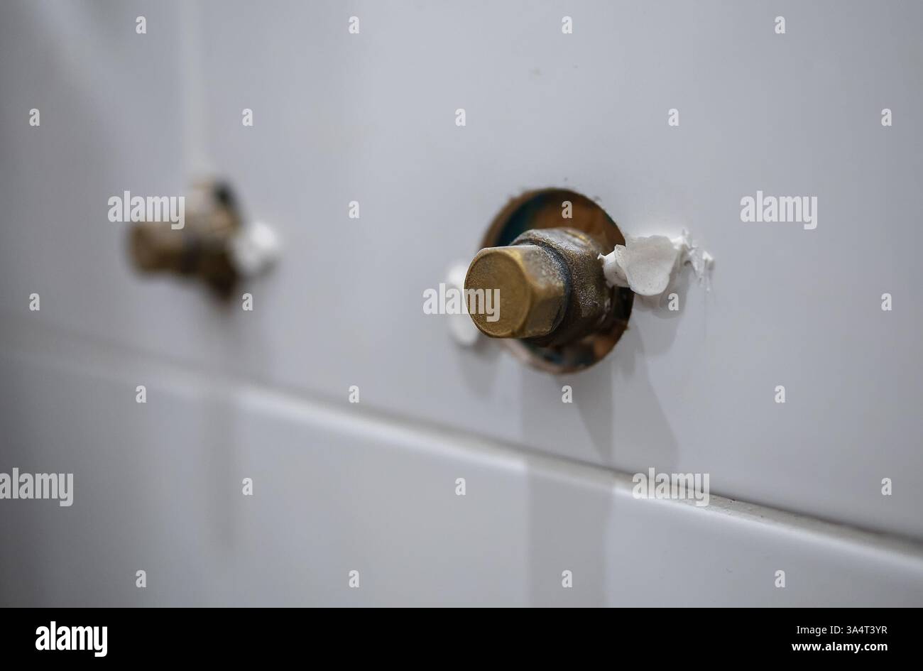 Metal caps used to seal pipes when removing a faucet Stock Photo - Alamy