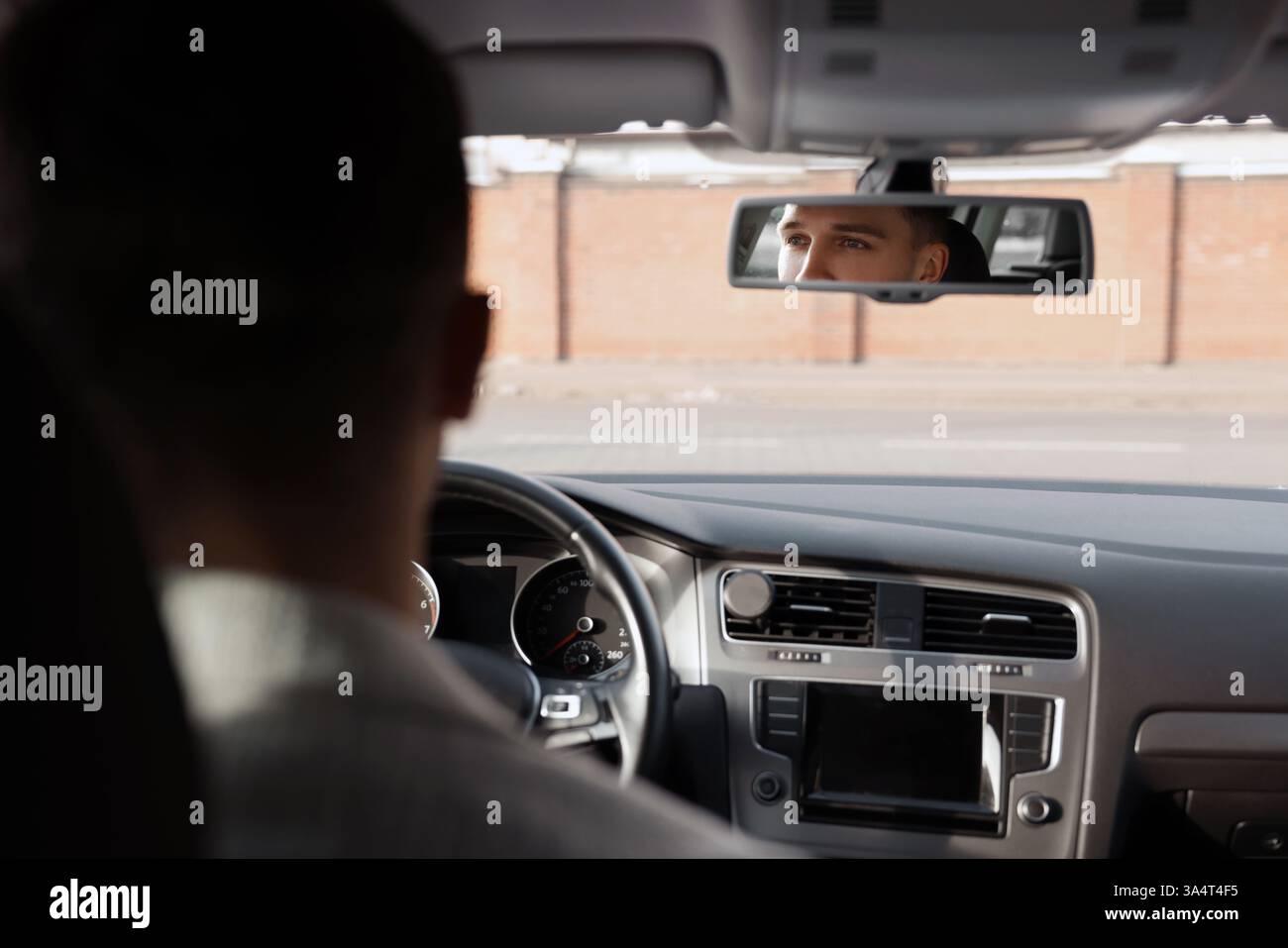 Driver behind steering wheel of modern car, view from inside Stock ...
