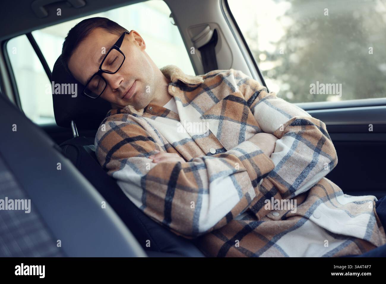 Tired driver sleeping in his modern car Stock Photo - Alamy