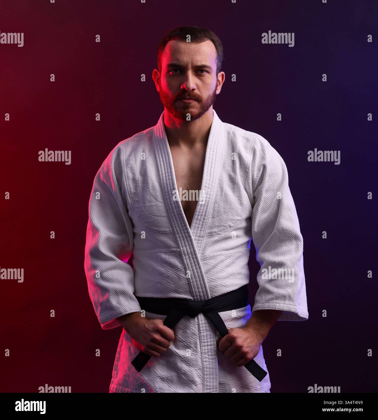 Karate fighter wearing uniform in color lights Stock Photo - Alamy
