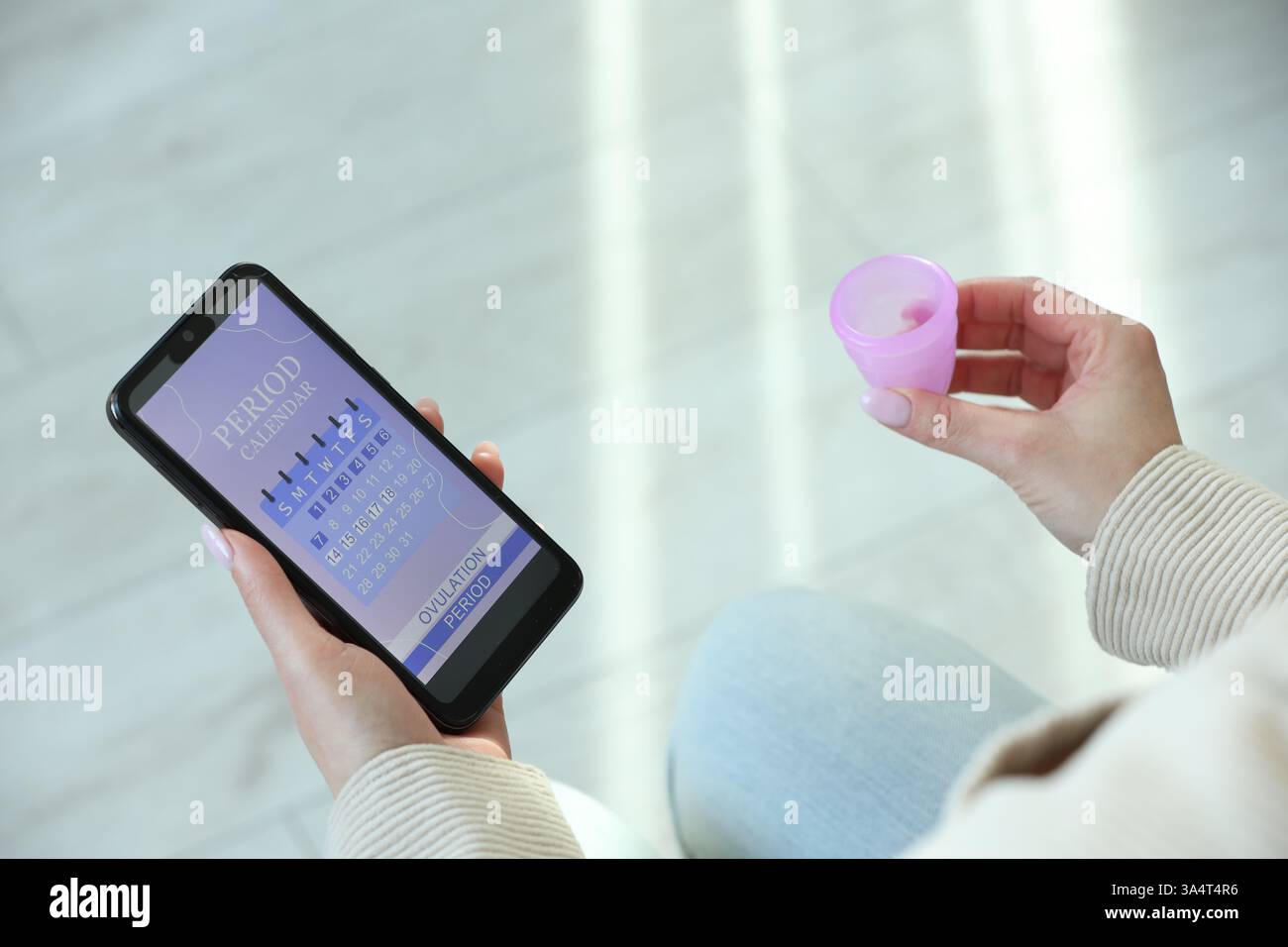 Menstruation. Woman with menstrual cup using period calendar ...