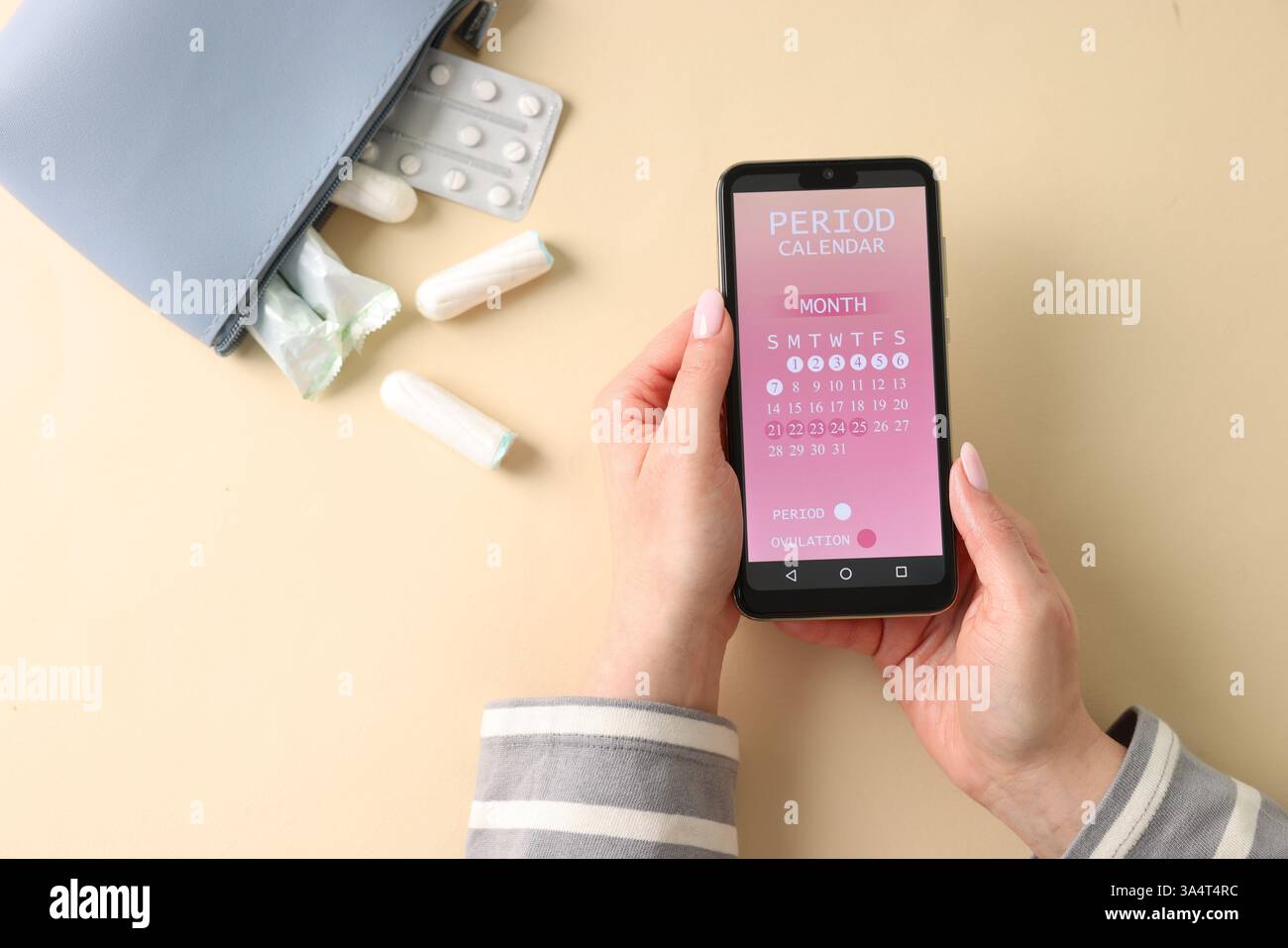 Menstruation. Woman holding smartphone with period calendar application ...