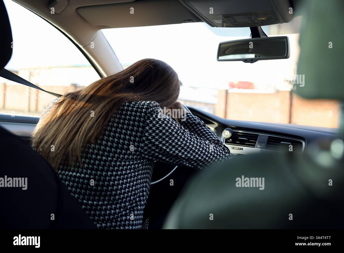 Tired driver sleeping on steering wheel in car, view from inside Stock ...